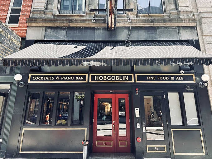 Dark wood trim and golden signage promise cocktails and piano music in a cozy hideaway worth discovering.