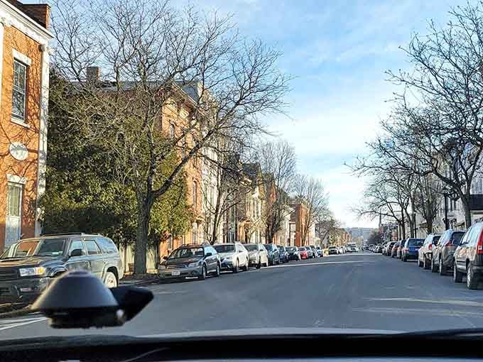 Bare winter trees frame historic buildings along streets that have witnessed generations of stories and Sunday drives.