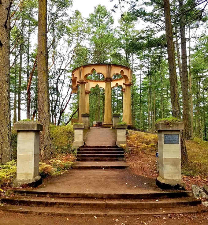 A bronze plaque at the entrance hints at the remarkable story waiting at the top of those mossy stairs.