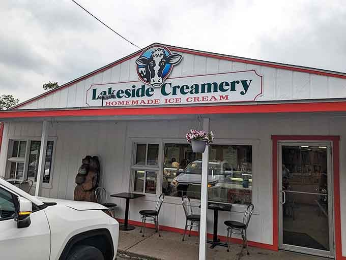 The cheerful cow logo on Lakeside Creamery's white and red building is basically a billboard for pure homemade happiness.