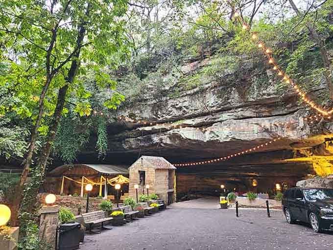 The cave entrance glows with string lights, creating an enchanted atmosphere that makes you believe in magic again.