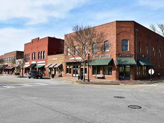Green awnings and warm brick storefronts line Madison's downtown block, quietly inviting you to slow down and stay awhile.