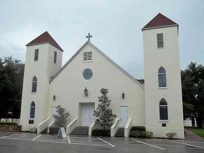 Twin towers frame the entrance to this beautiful white church, where symmetry and simplicity create an elegant architectural statement.