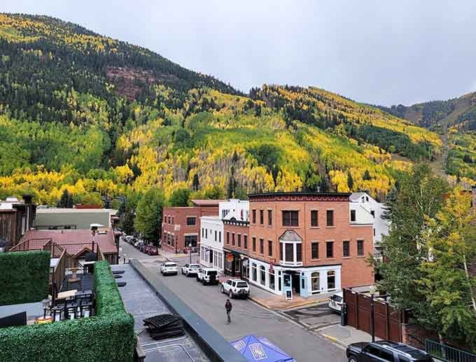 Fall colors paint the hillsides in gold and amber, framing these historic buildings in nature's most spectacular display.