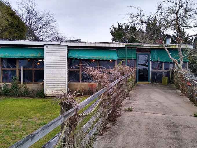 Teal awnings and a weathered fence give this quiet side of The Wreck a moody, atmospheric charm all its own.