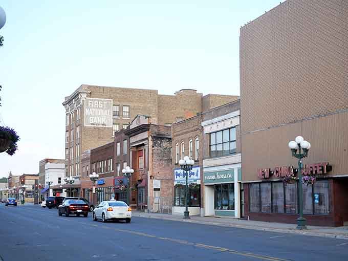The faded First National Bank sign on Virginia's main street whispers stories of boom times past.