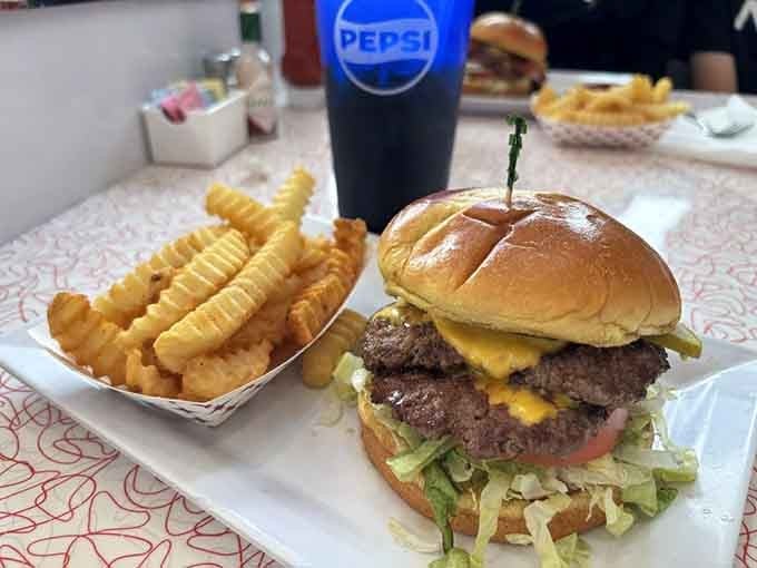 Two smashed patties, golden crinkle-cut fries, and an ice-cold Pepsi. The holy trinity of a proper diner lunch.