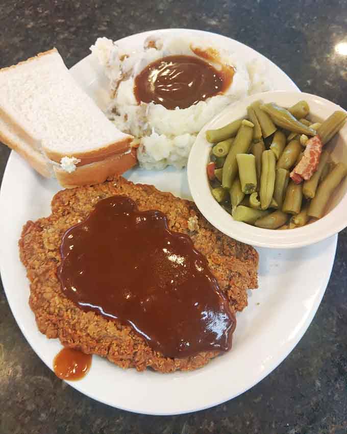 Country fried steak with gravy, mashed potatoes, and green beans. Grandma's Sunday dinner, served any day you need it.