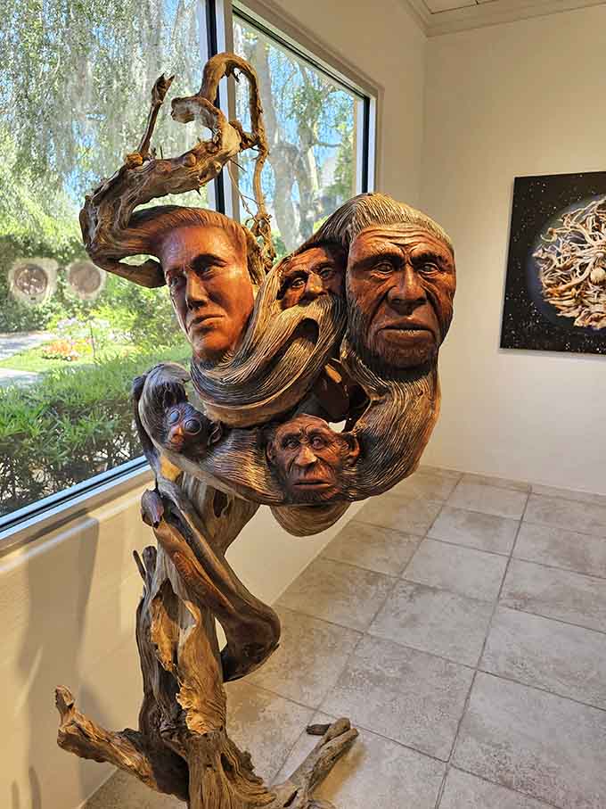 This remarkable indoor sculpture weaves human faces and primate forms together through twisted wood. It'll make you think twice.