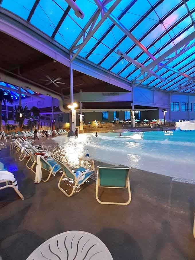 Lounge chairs lined up beside a glowing wave pool. This is what "unwinding" actually looks like.