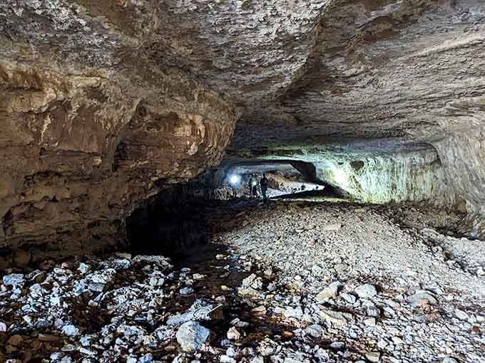 Headlamps cutting through ancient Ozark limestone &mdash; this natural tunnel reminds you the earth has been busy long before us.