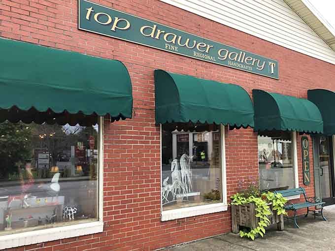 Green awnings beckon art lovers inside where handcrafted treasures await discovery along the charming main street.