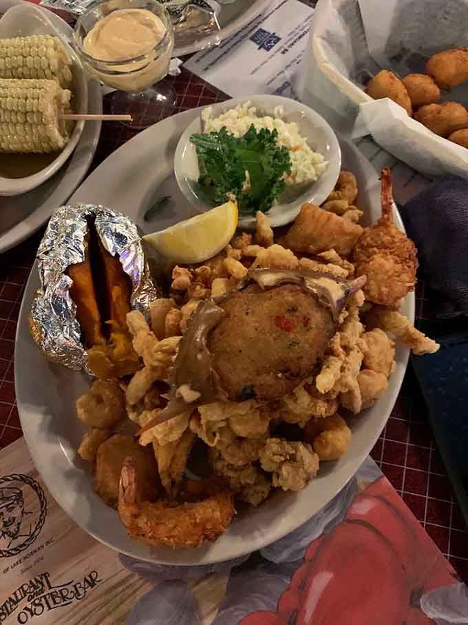 Behold the seafood platter of your dreams: fried shrimp, scallops, crab cake, and enough golden goodness to feed a crew.