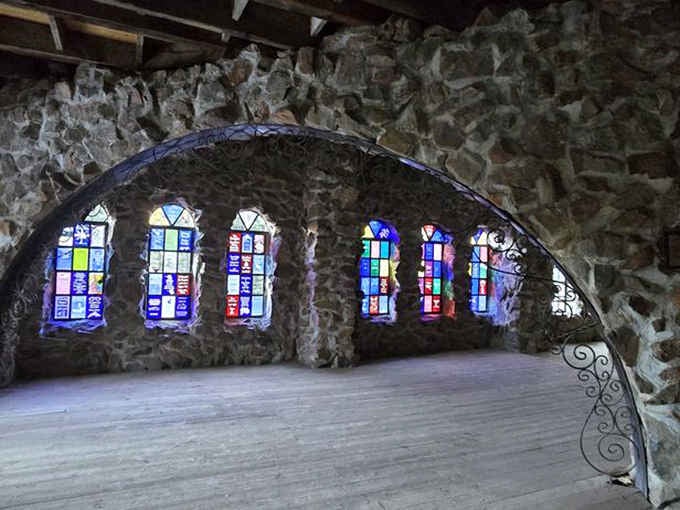 Colorful glass transforms sunlight into rainbow patterns across floors, proving beauty lives in the details of this mountain masterpiece.