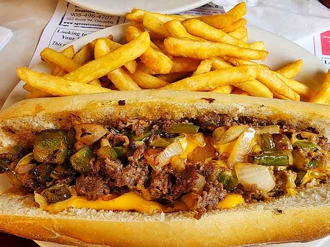 Half a pound of cheesesteak glory, loaded with peppers and onions, served with a mountain of fries.