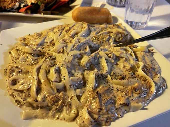 Jerk pork alfredo pasta proves that fusion cuisine can be beautiful when someone actually knows what they're doing here.