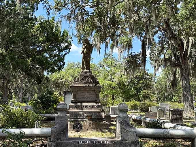 The Seiler monument stands tall and proud, a stone guardian keeping watch under curtains of Spanish moss.