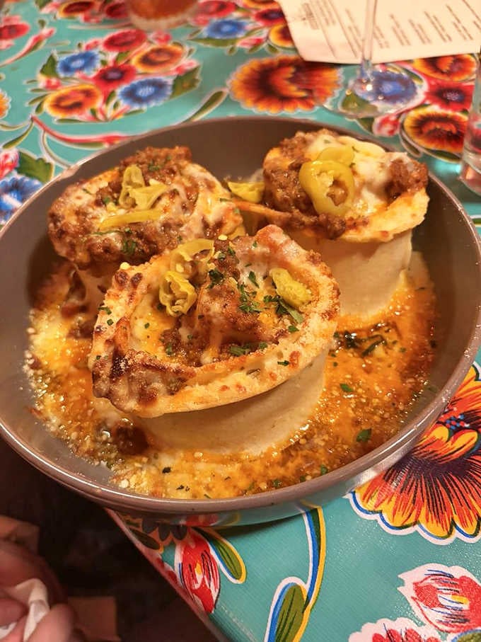 Three bubbling, cheesy pasta rounds arrive like little edible gifts you never knew Indiana owed you.