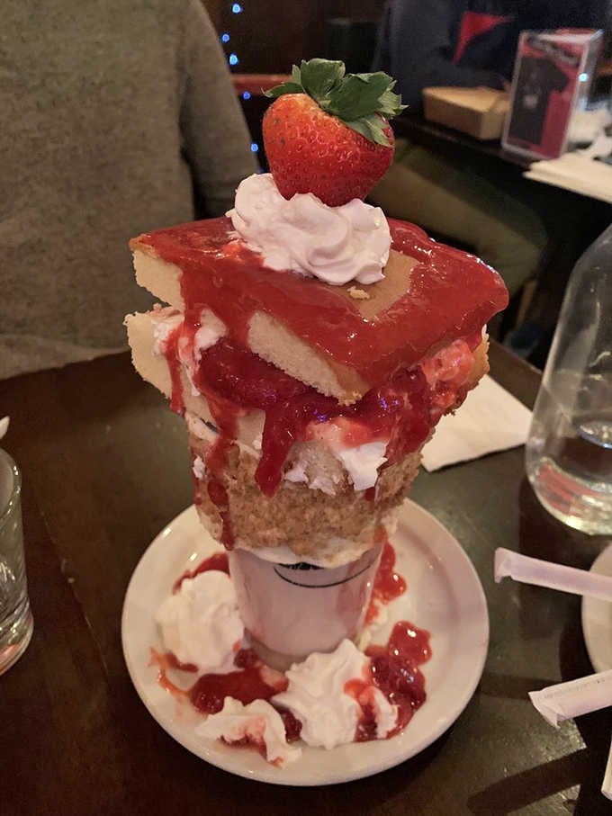 Strawberry shortcake decided a plate wasn't dramatic enough and climbed on top of a milkshake instead.