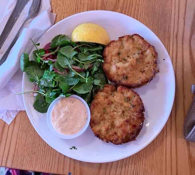 A fresh spinach salad alongside perfectly crusted crab cakes. Simple, honest, and exactly the kind of meal that makes you feel good.