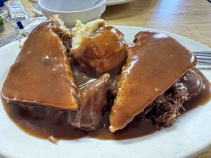 Open-faced, smothered in rich brown gravy, and piled high with tender roast beef &mdash; this is comfort food wearing a crown.