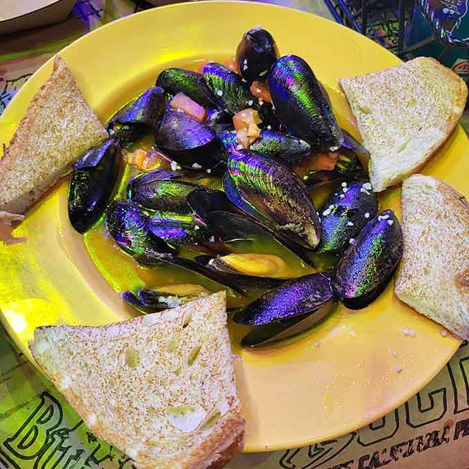 Saut&eacute;ed mussels served on a sunny yellow plate with toast. Simple, beautiful, and absolutely worth the mess.