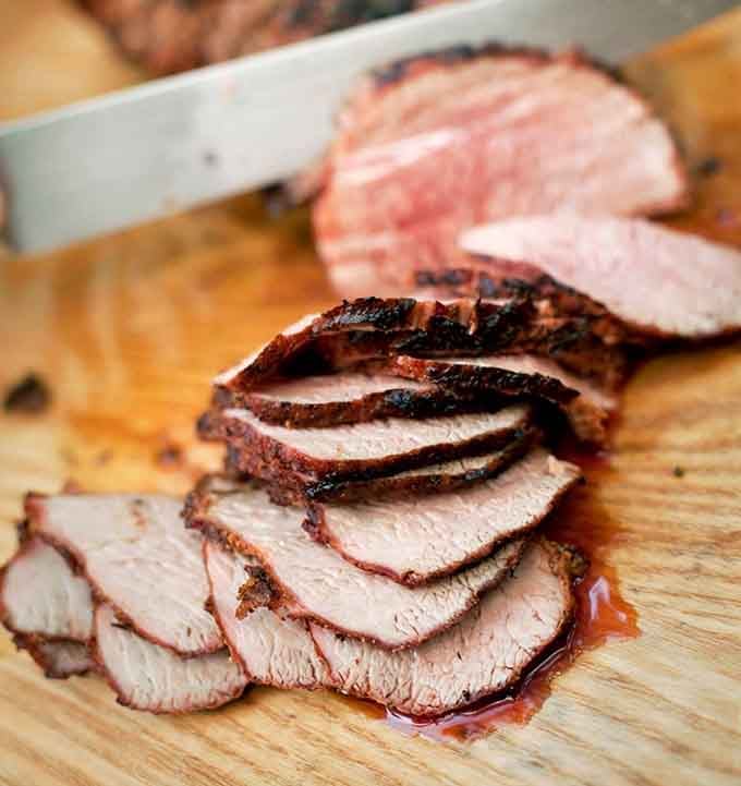 That dark, crackling bark on freshly sliced smoked meat tells you everything about the care that went into making it.