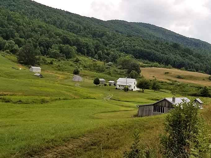Rolling hills, weathered barns, and mountain walls that hug the valley like nature's own protective embrace.