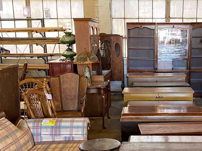 Explore rows of beautifully crafted wooden dressers, glass cabinets, vintage lamps, and cozy patterned chairs waiting for a new home.