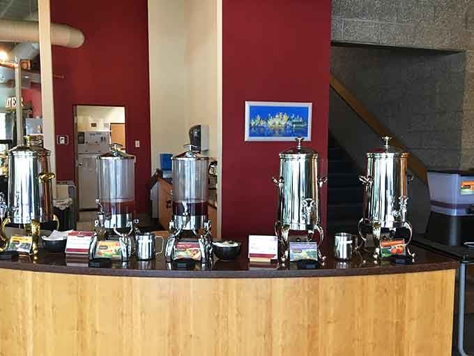 Four polished tea urns lined up and ready, like a very civilized, very aromatic version of a greatest hits album.