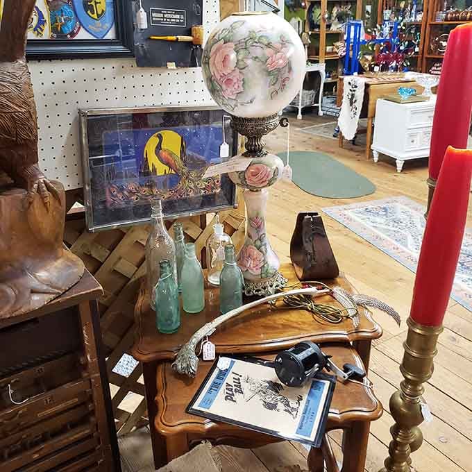 A hand-painted globe lamp, vintage bottles, and a "Play Ball" print sharing one table like old friends.