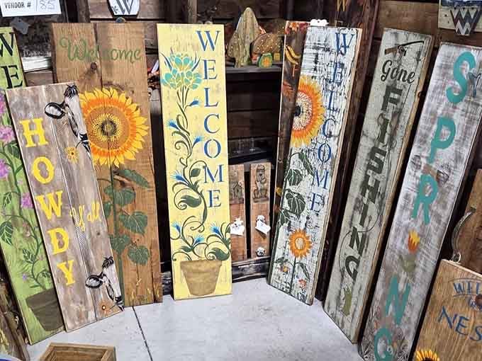 Hand-painted wooden porch signs bursting with sunflowers and personality, proof that front porches still matter deeply.