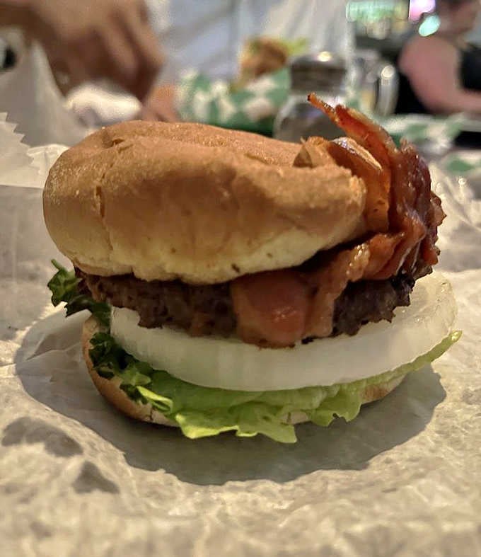 Crispy bacon stacked high on a fresh patty with lettuce and onion. The Bacon Burger here celebrates bacon like it deserves.