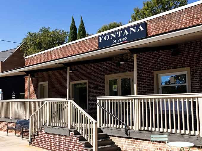 That clean navy signage on warm red brick at Fontana Di Vino is basically Italian for "yes, you absolutely deserve a glass of wine."