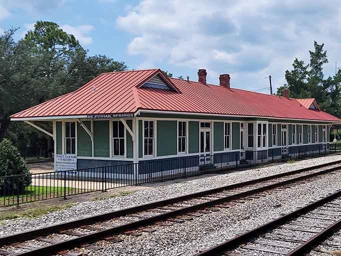 The old DeFuniak Springs train depot wears its red roof like a crown. History never looked this well-dressed.