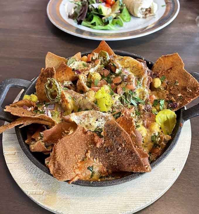 Greek nachos piled high with crispy chips and Mediterranean flavors, because fusion food done right knows no boundaries.