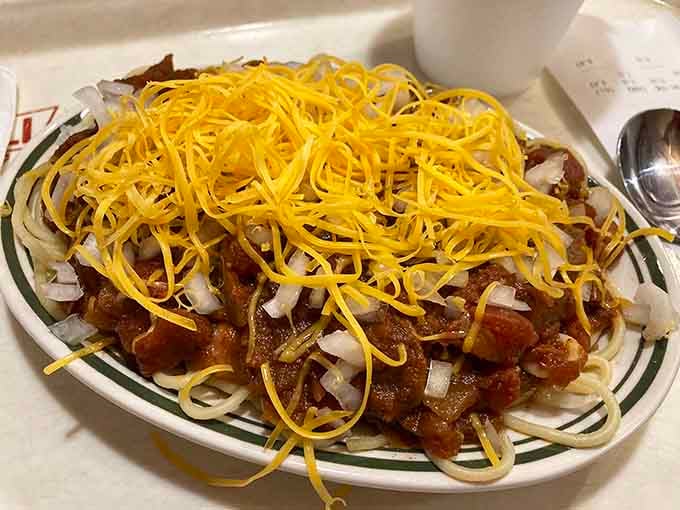 The three-way: spaghetti, chili, and enough shredded cheese to make your cardiologist schedule an intervention, but worth every bite.
