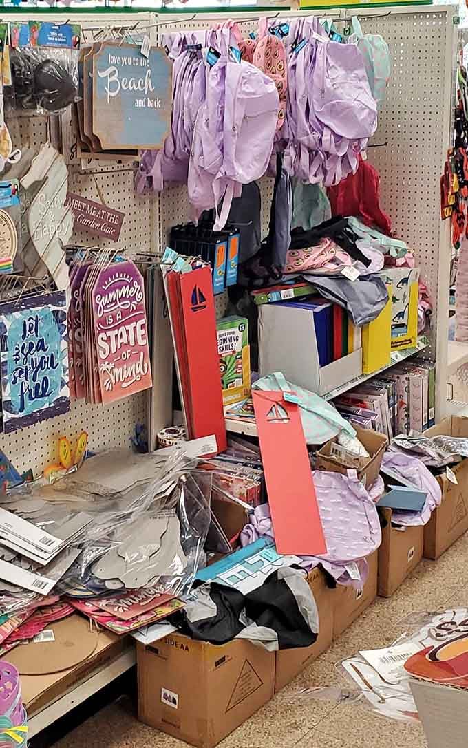 Decorative signs, bags, and backpacks all piled together, because great finds don't always come neatly organized on a shelf.