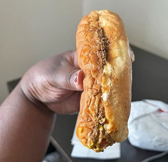 A chili bun so generously topped it looks like it's wearing a delicious winter coat made entirely of meat and happiness.