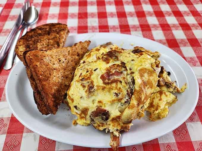 An omelet so generously stuffed, it looks like it's trying to smuggle ingredients across state lines.
