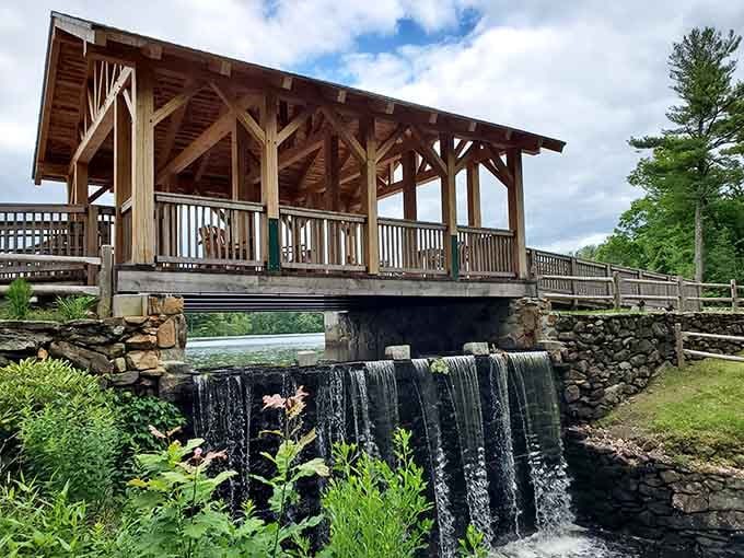 The covered bridge and waterfall combo is basically New England showing off, and we're not complaining one bit.