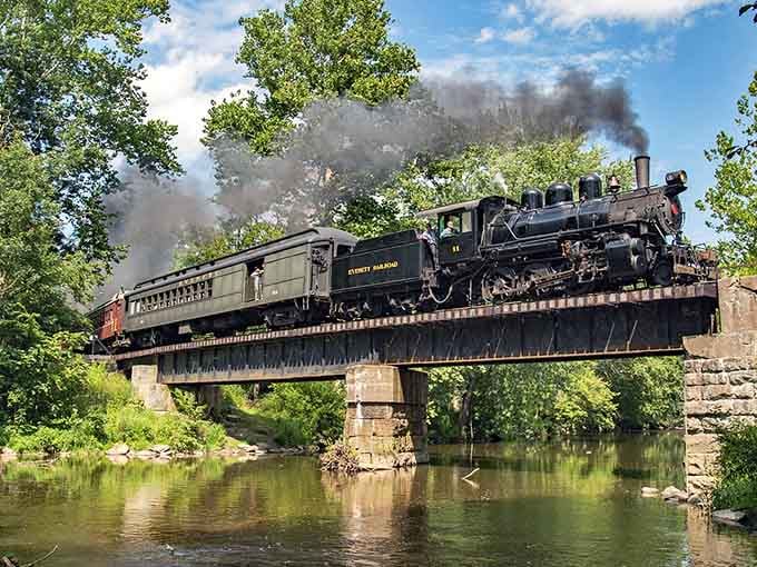 Crossing a river bridge with steam trailing overhead. This is the kind of shot that breaks the internet.