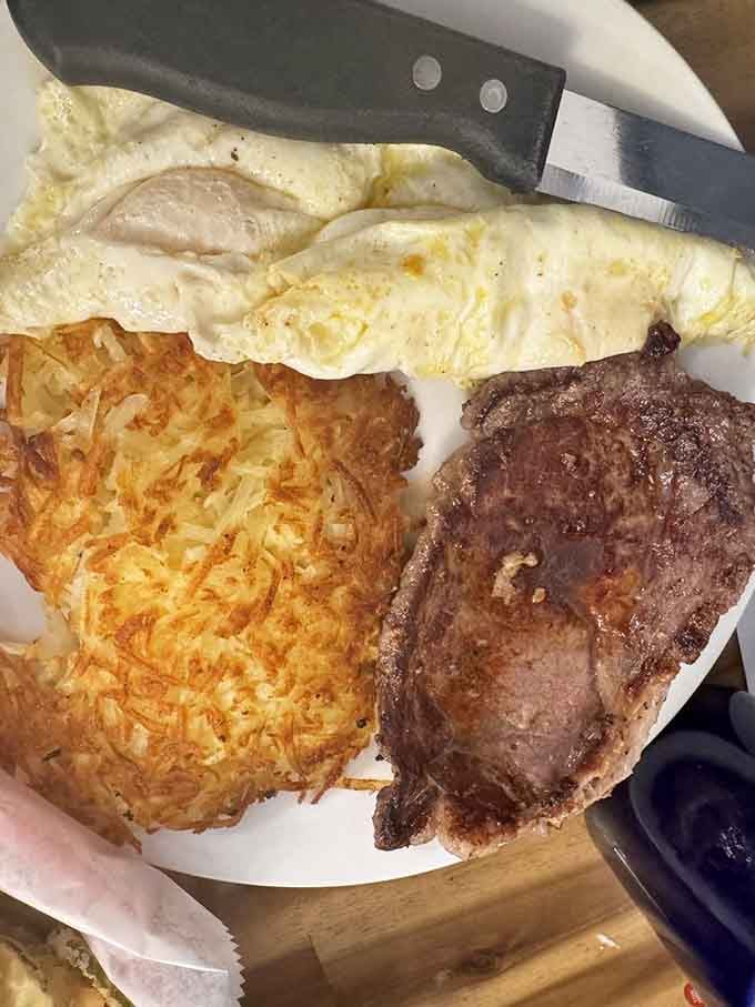 A golden hash brown, two sunny eggs, and a seared steak. Breakfast that means serious business.