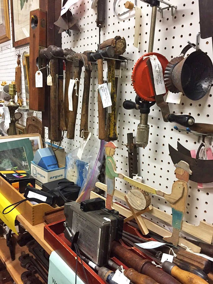 Old hammers, hand drills, and tools your grandfather would recognize, all lined up like veterans at a reunion.