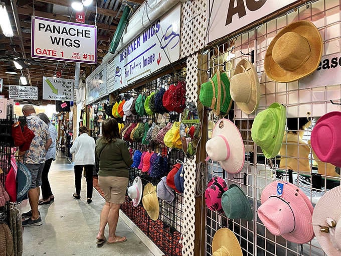 A rainbow wall of hats at Panache Wigs and accessories. Your next great look is hanging right there.