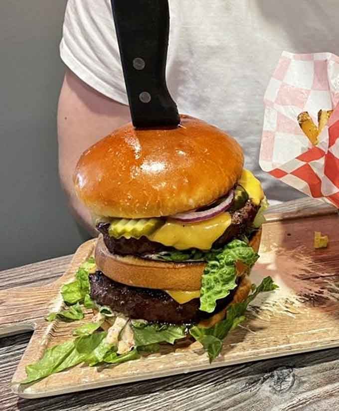 When a burger needs a knife planted through it just to stay upright, you know things are getting serious.