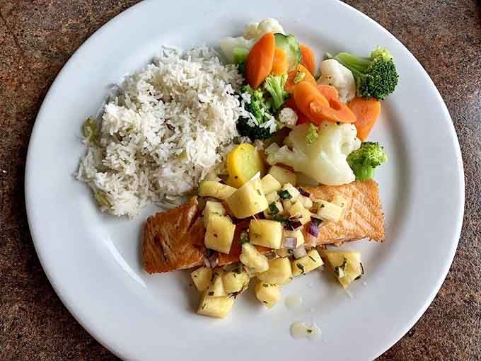 Salmon topped with fresh salsa brings Pacific Northwest flavors together in one beautifully plated, colorful masterpiece worth photographing.