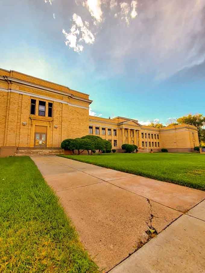 The local school building sits surrounded by green space, reminding us when education didn't require fortress-like security measures.