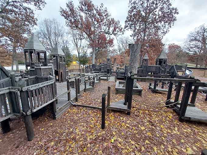 Autumn leaves blanket this playground like nature's own carpet, creating the perfect backdrop for childhood adventures and scraped knees.