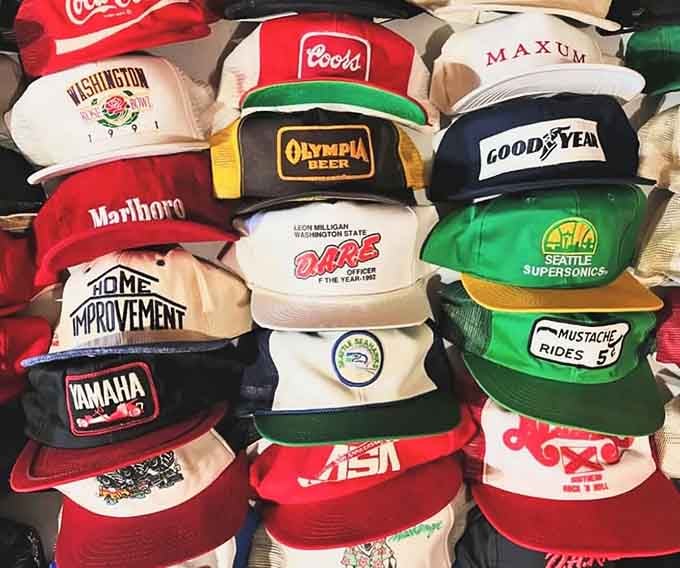 A wall of vintage caps so perfectly chaotic it could double as a museum exhibit on American nostalgia.